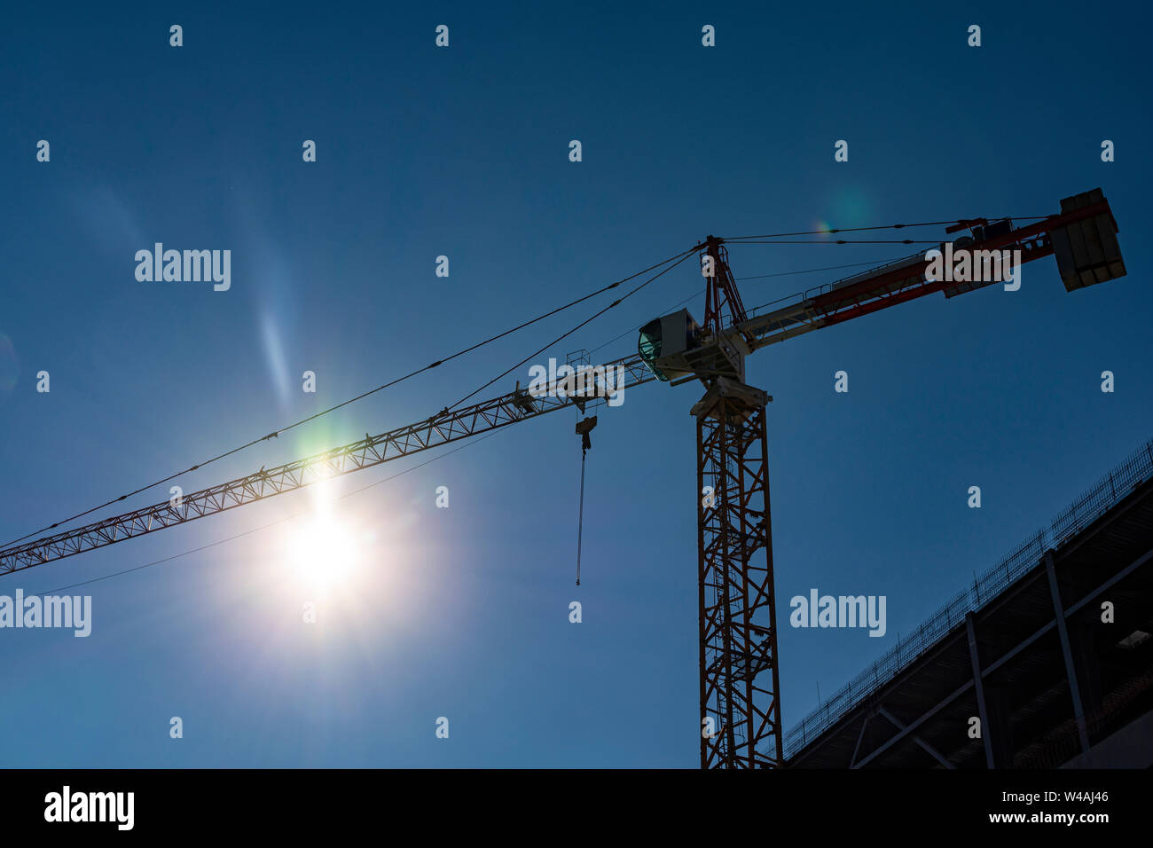Construction crane on blue sky with sunny background Stock Photo - Alamy