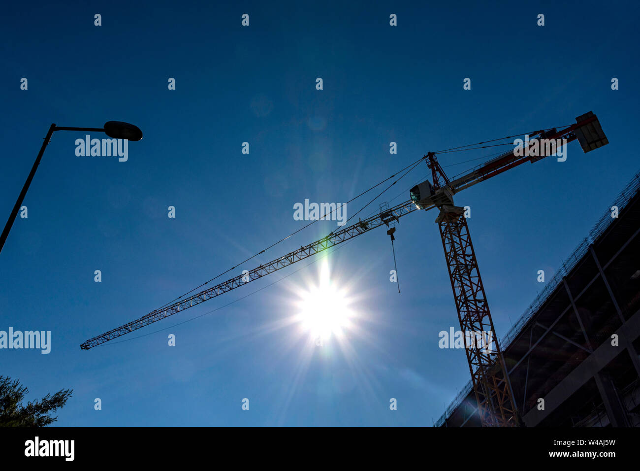 Construction crane on blue sky with sunny background Stock Photo - Alamy