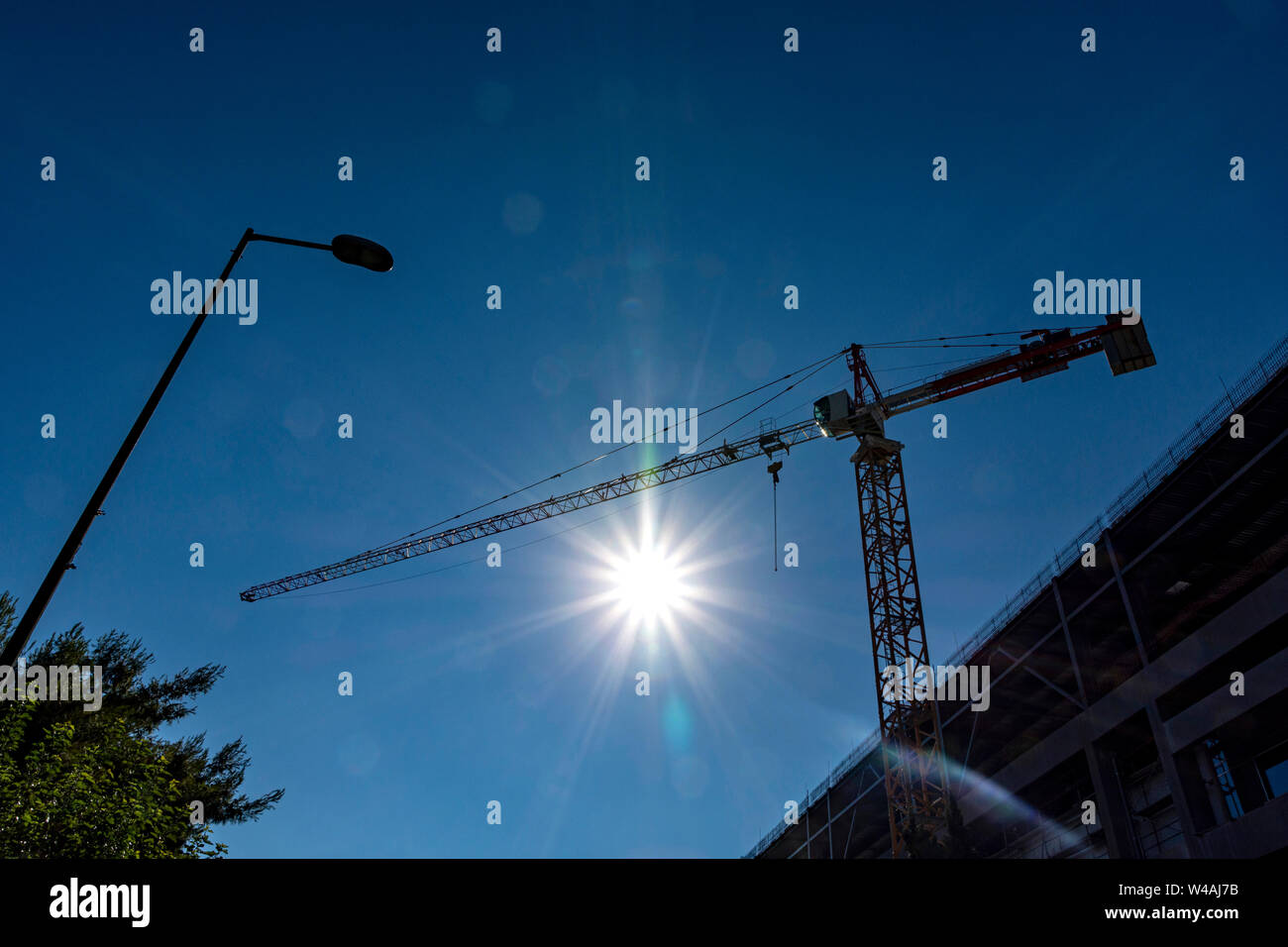 Construction crane on blue sky with sunny background Stock Photo - Alamy