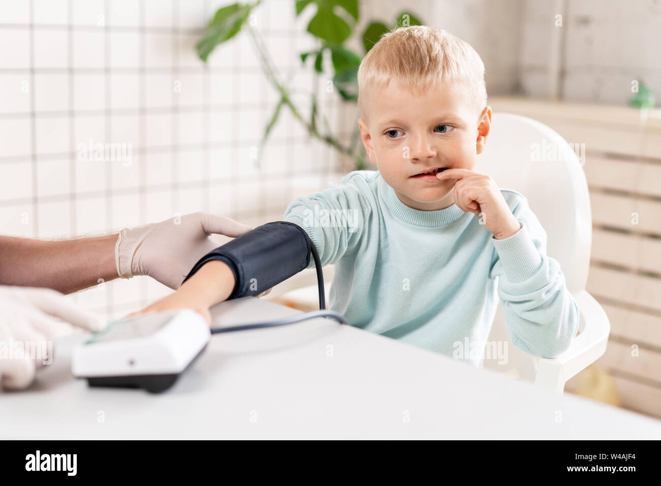Doctor measuring blood pressure of a little boy. Diagnostic, healthcare ...