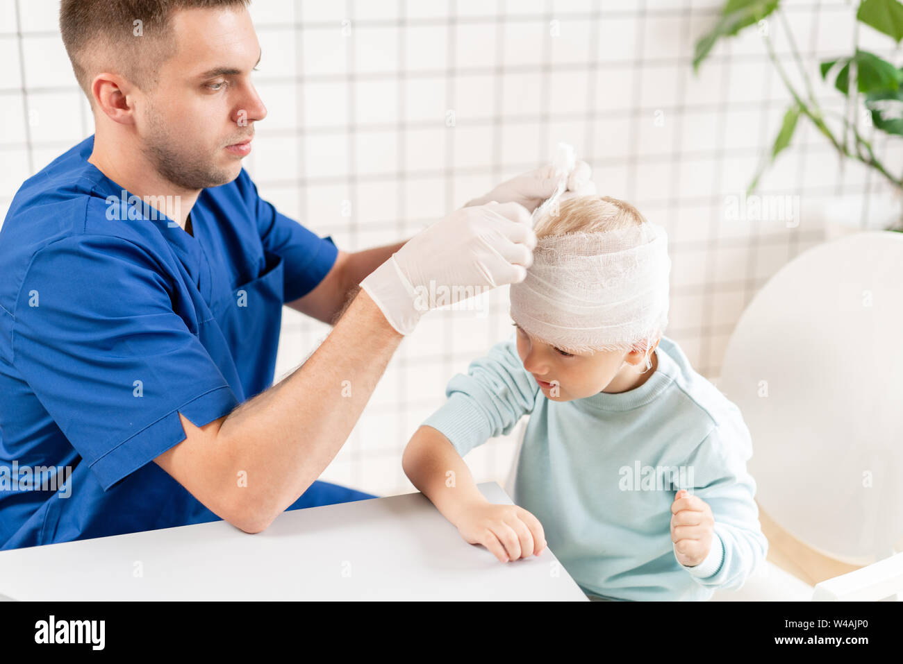 Boy touching head hi-res stock photography and images - Alamy