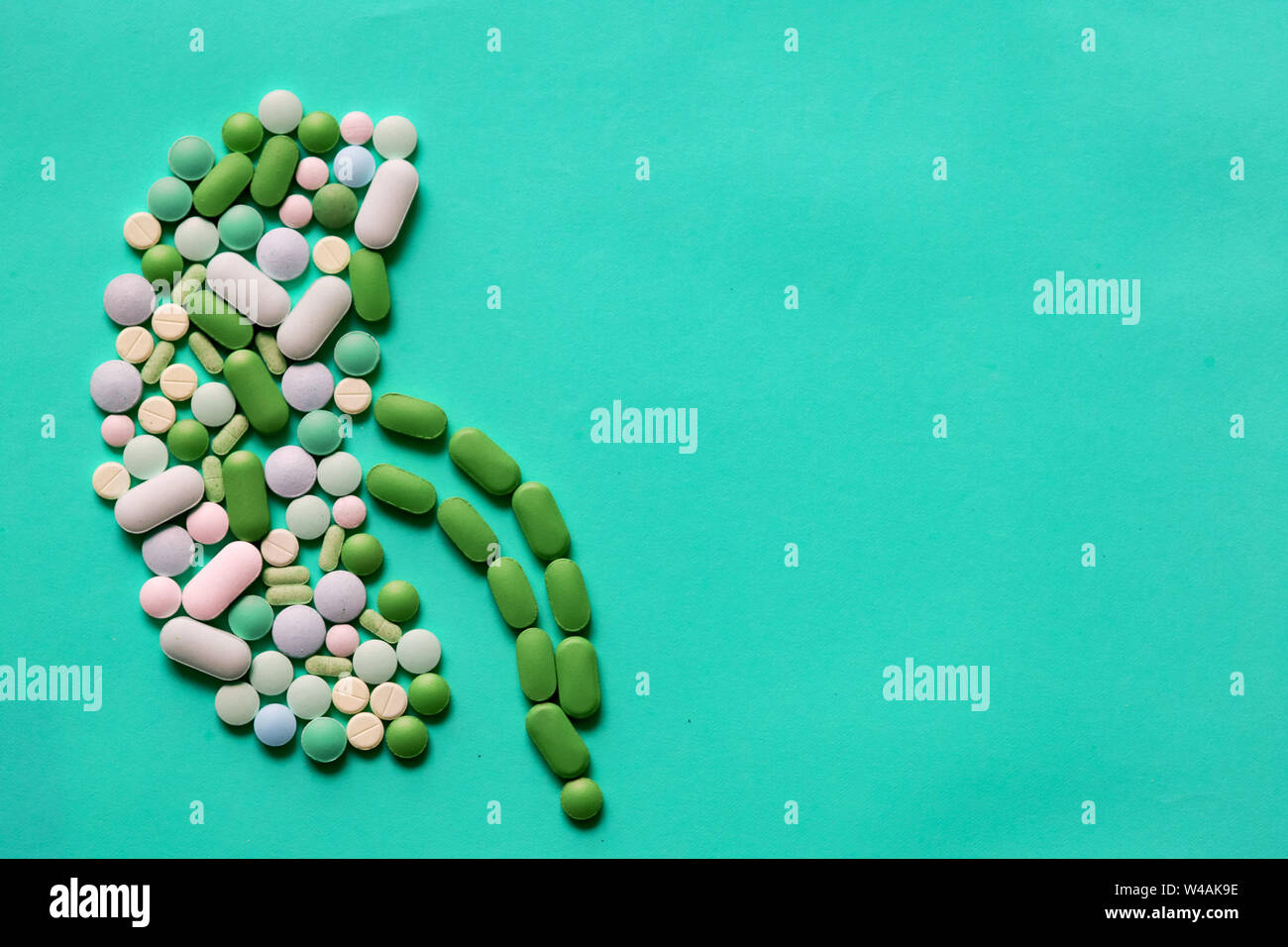 Medicine pills tablets capsules in shape of human kidney in blue ...