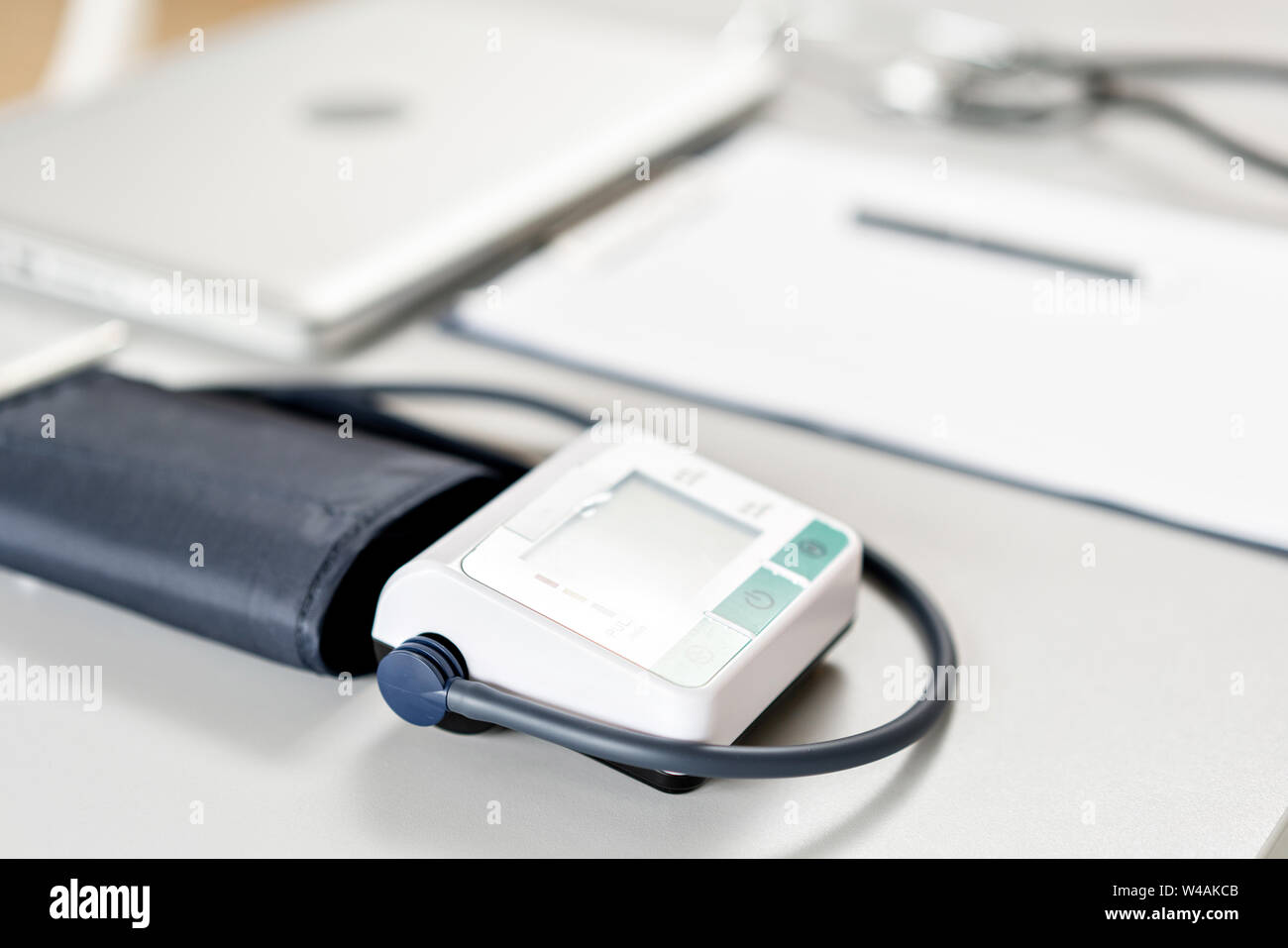 Stethoscope, measuring blood pressure and laptop on wooden desk for ...