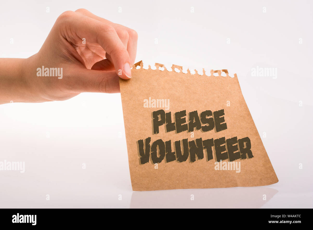 Hand holding paper with PLEASE VOLUNTEER wording on white Stock Photo ...