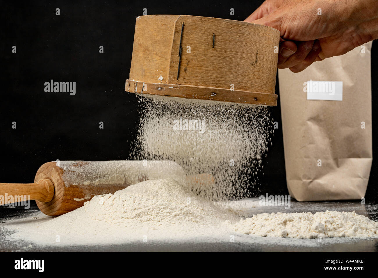 Flour sifting through strainer on hi-res stock photography and images ...
