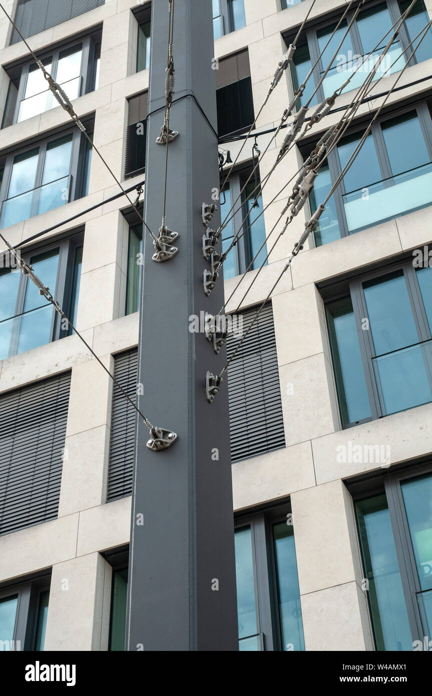 metal post in front of a modern office building with fixed power supply ...