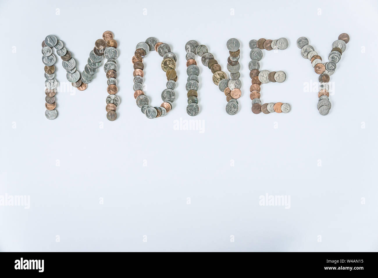Coins isolated on solid white background spelling the word Money from ...