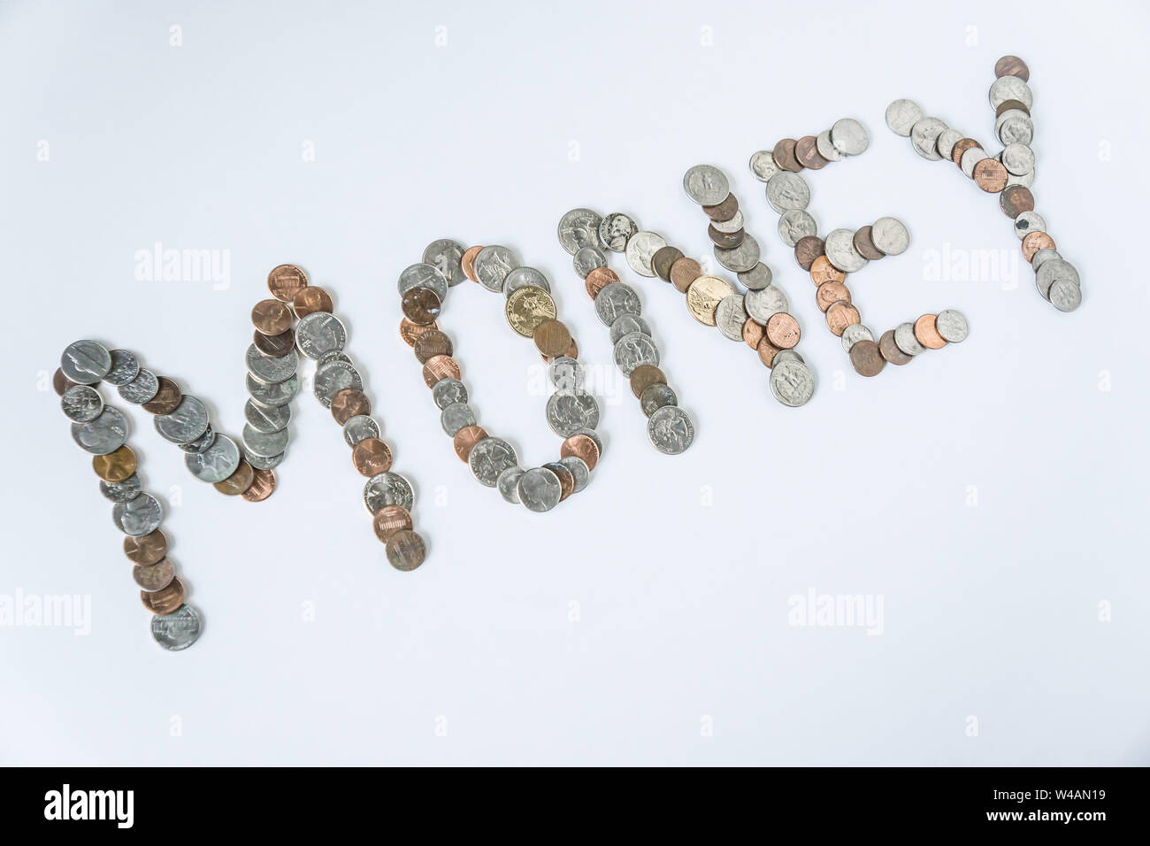 Coins isolated on solid white background spelling the word Money from ...