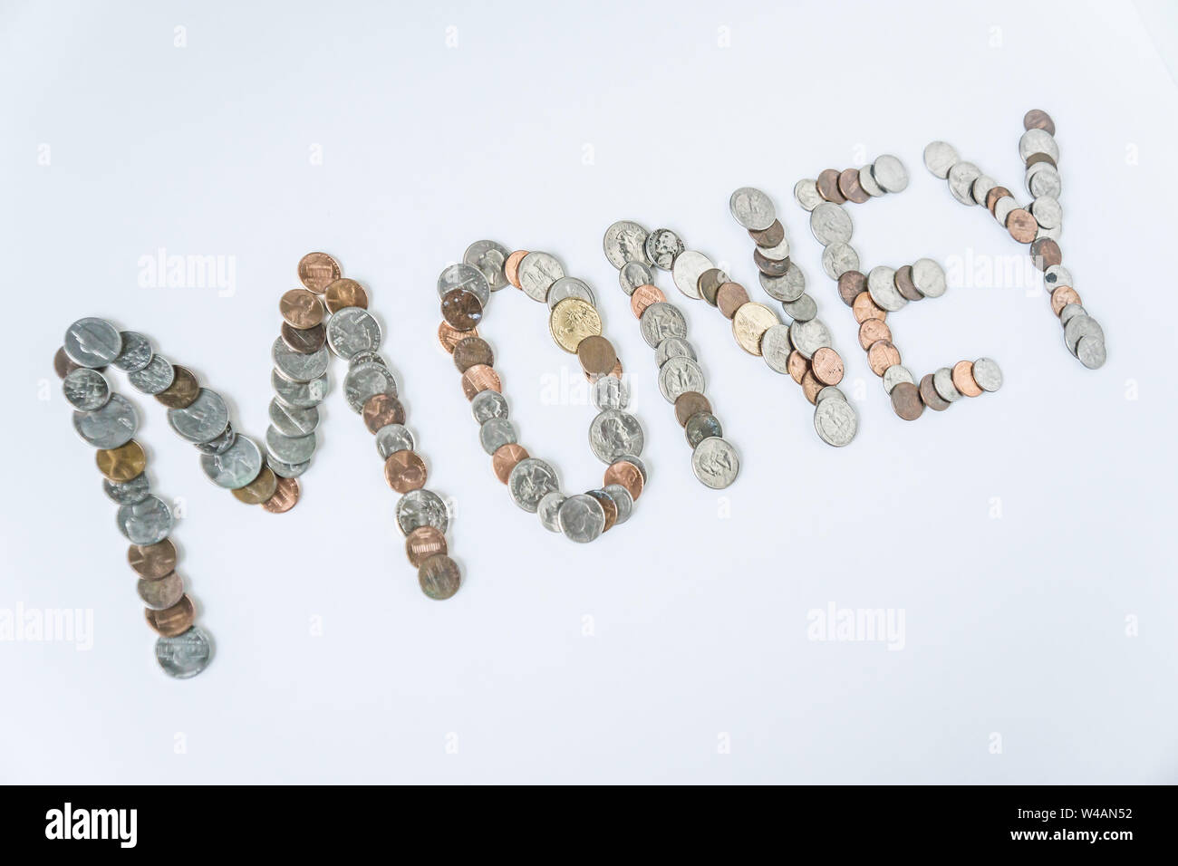 Coins isolated on solid white background spelling the word Money from ...
