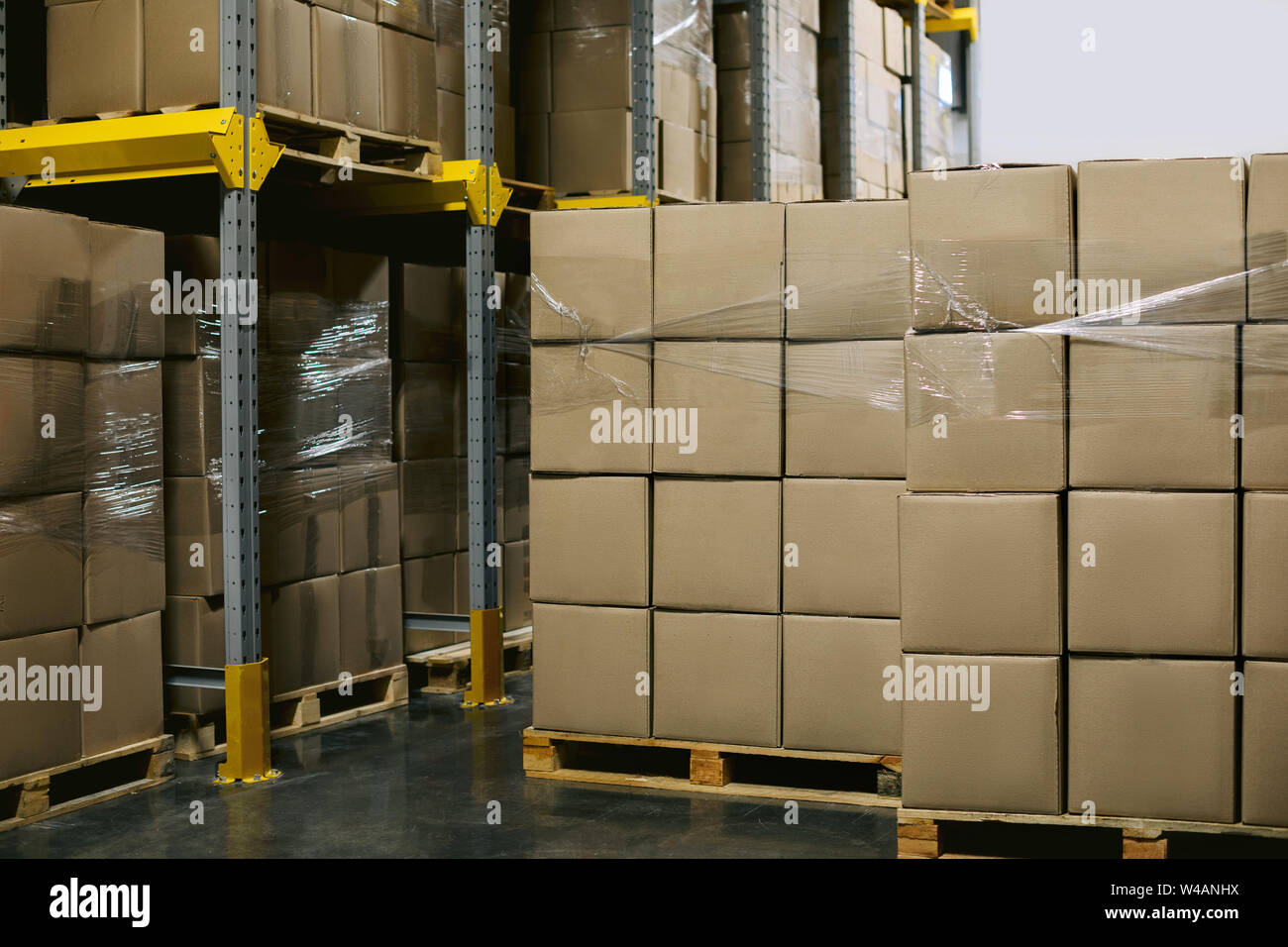 Cardboard boxes on shelves at logistics warehouse Stock Photo - Alamy