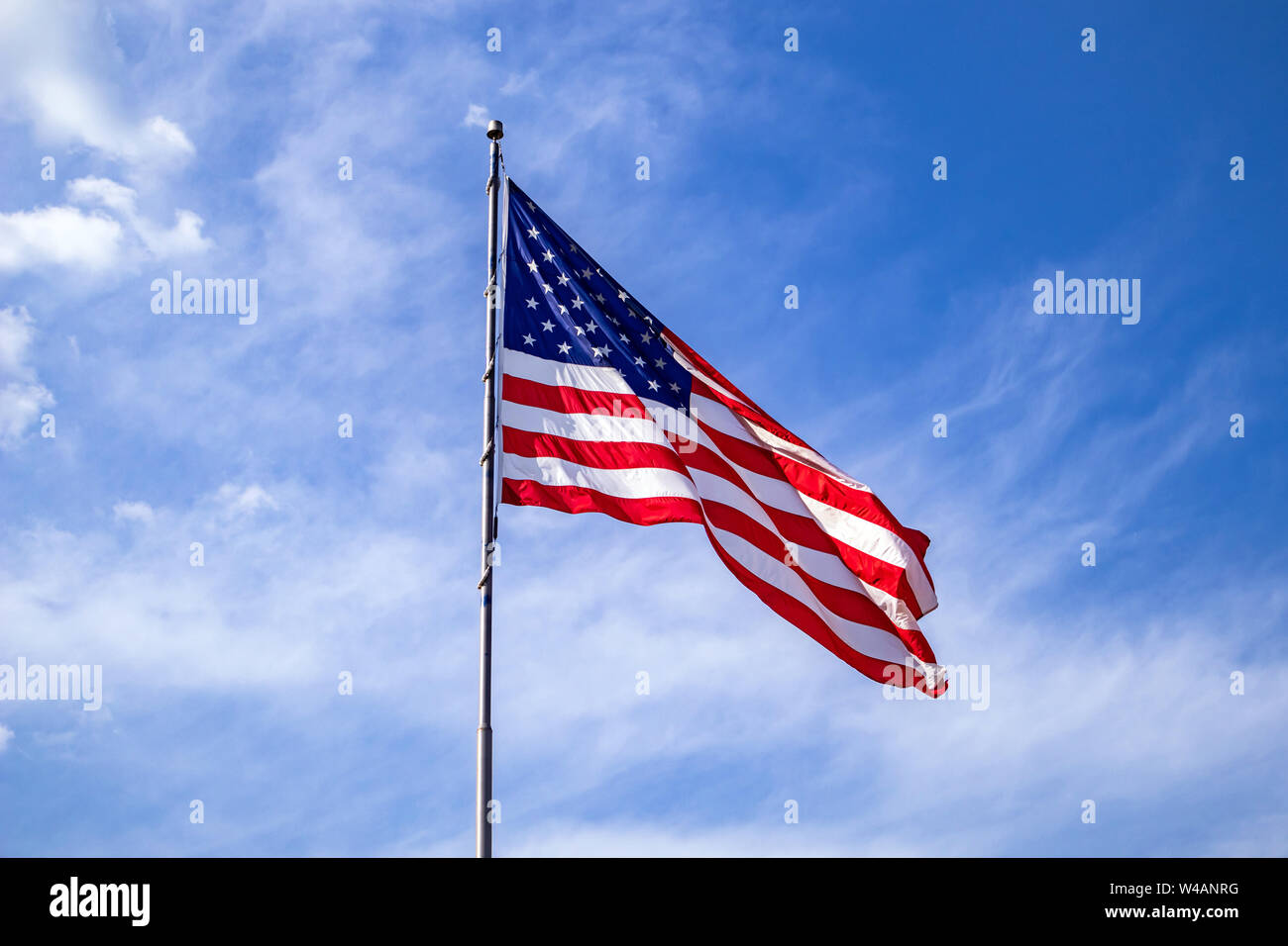 USA symbol. United States of America flag on a pole waving isolated ...
