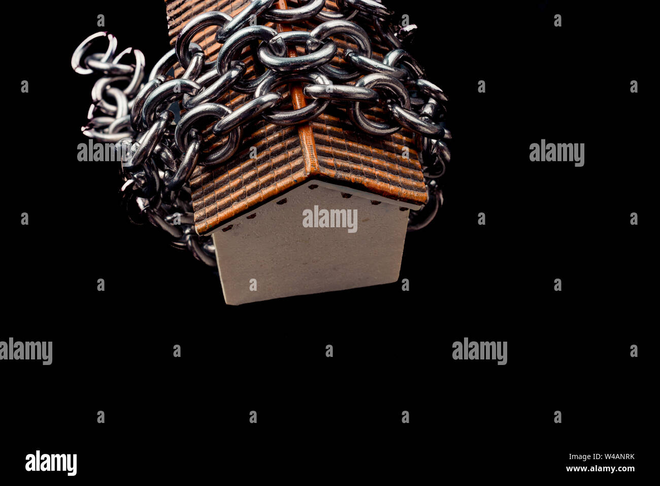 Chain around a little model house in the view Stock Photo - Alamy