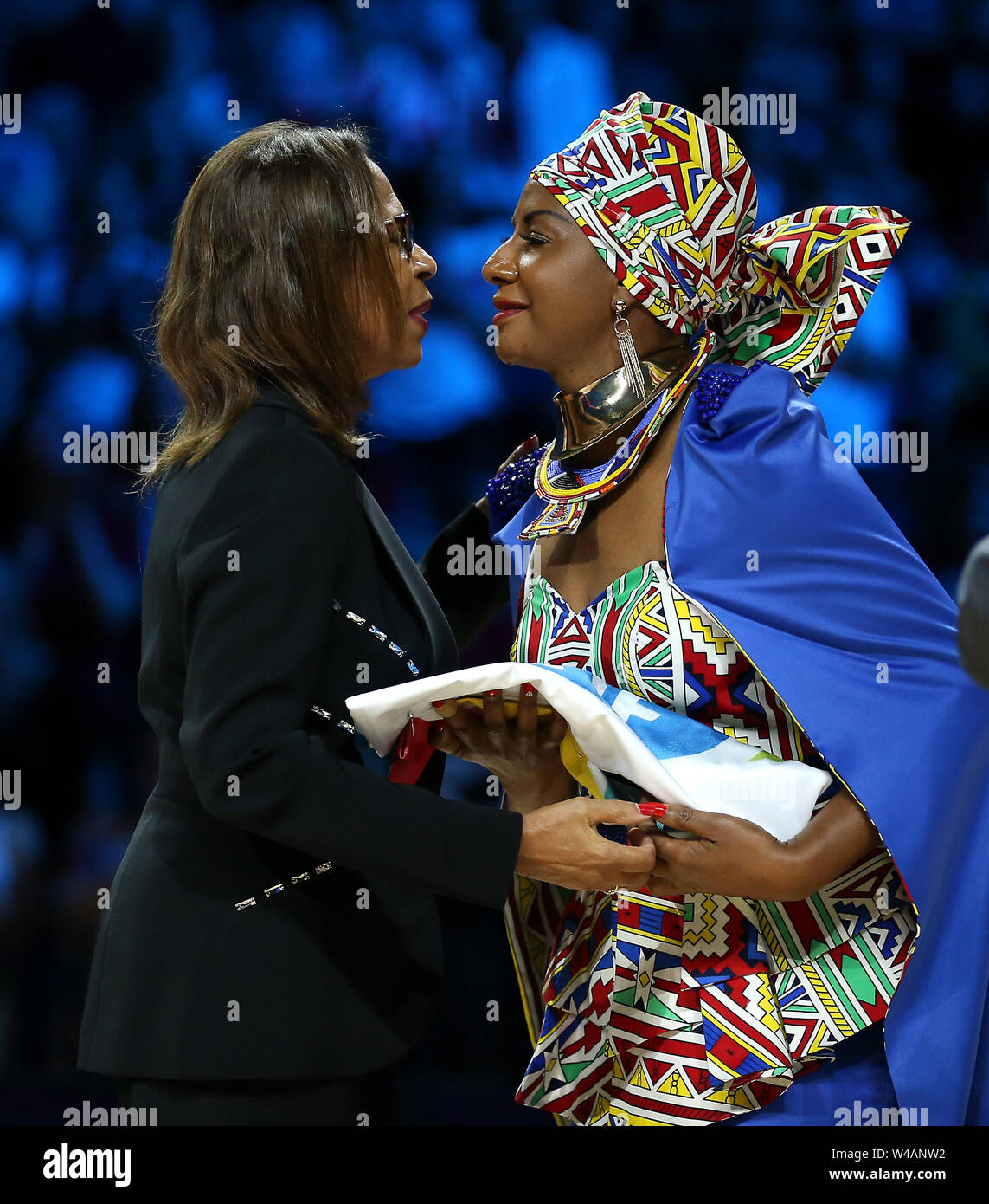 International Netball Federation President Molly Rhone hands the flag ...