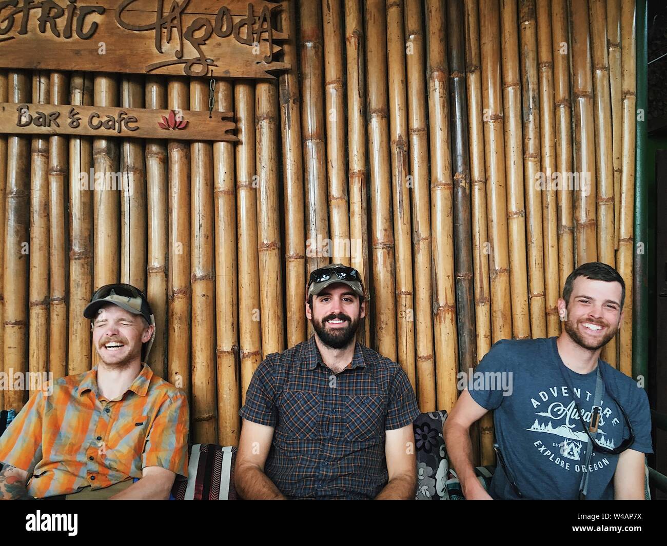 Three happy men laughing and smiling with bamboo backdrop Stock Photo ...