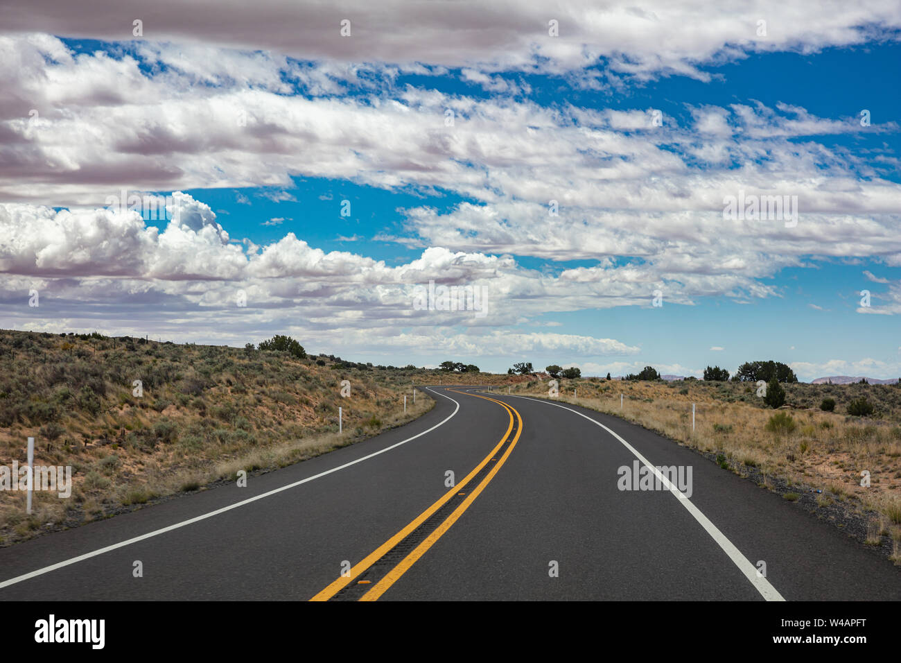 Highway in a sunny spring day, countryside USA. Empty winding road ...