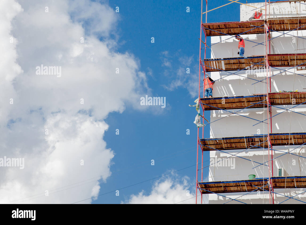 Scaffolding on a multistory building. Warming of the outer wall panel ...