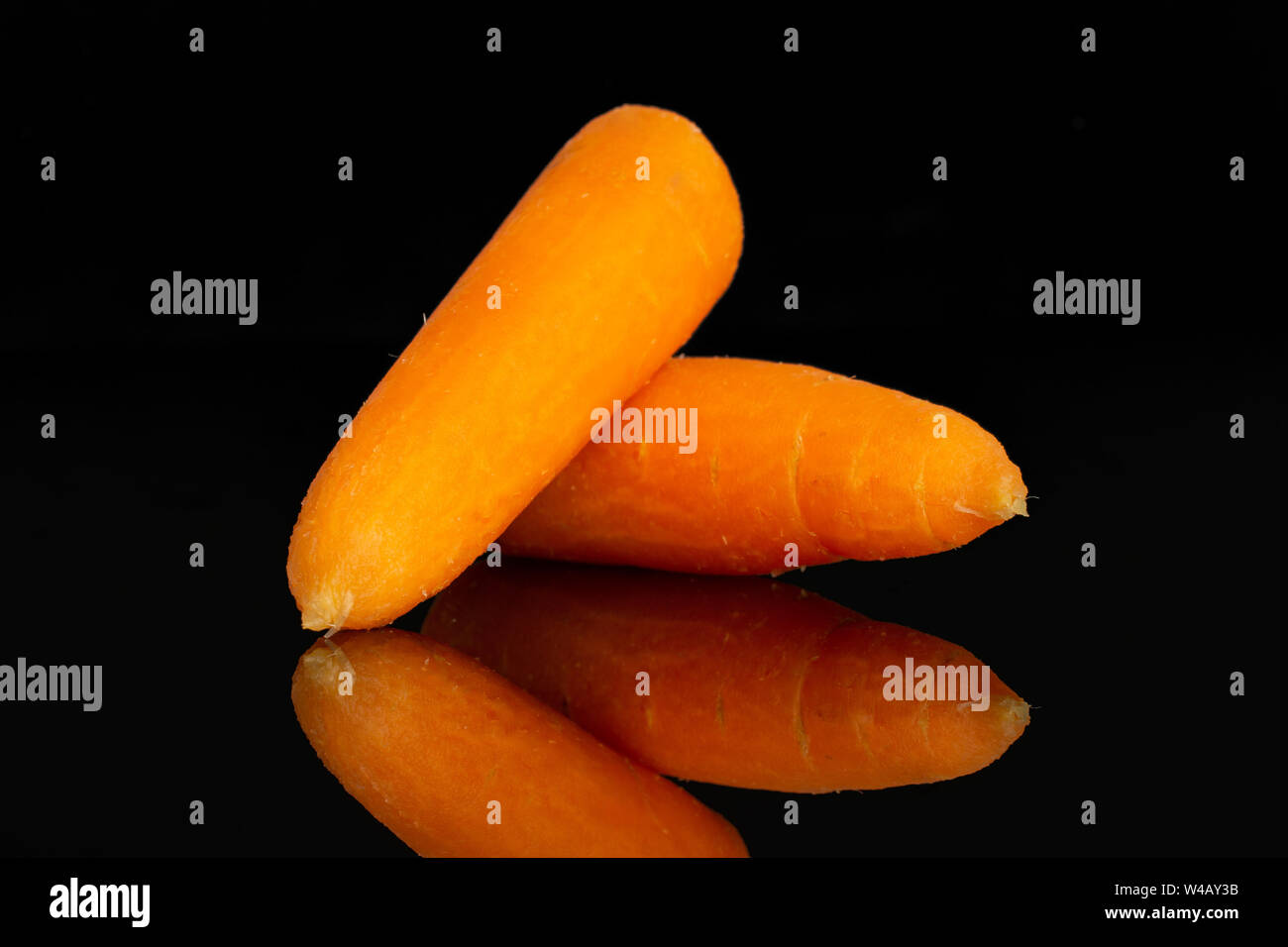 Group of two whole fresh peeled orange baby cut carrot isolated on ...