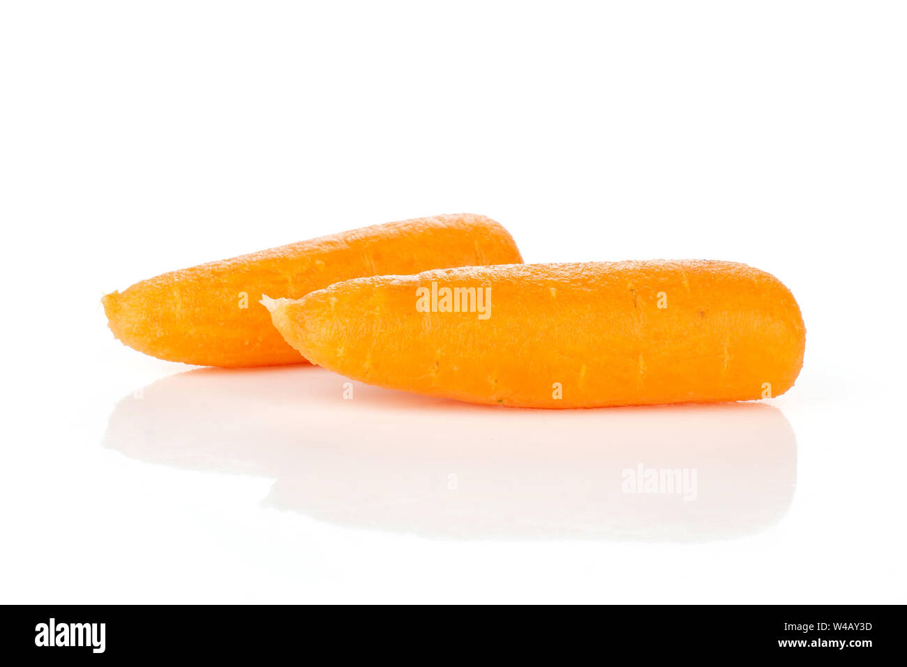 Group of two whole fresh peeled orange baby cut carrot isolated on white background Stock Photo ...