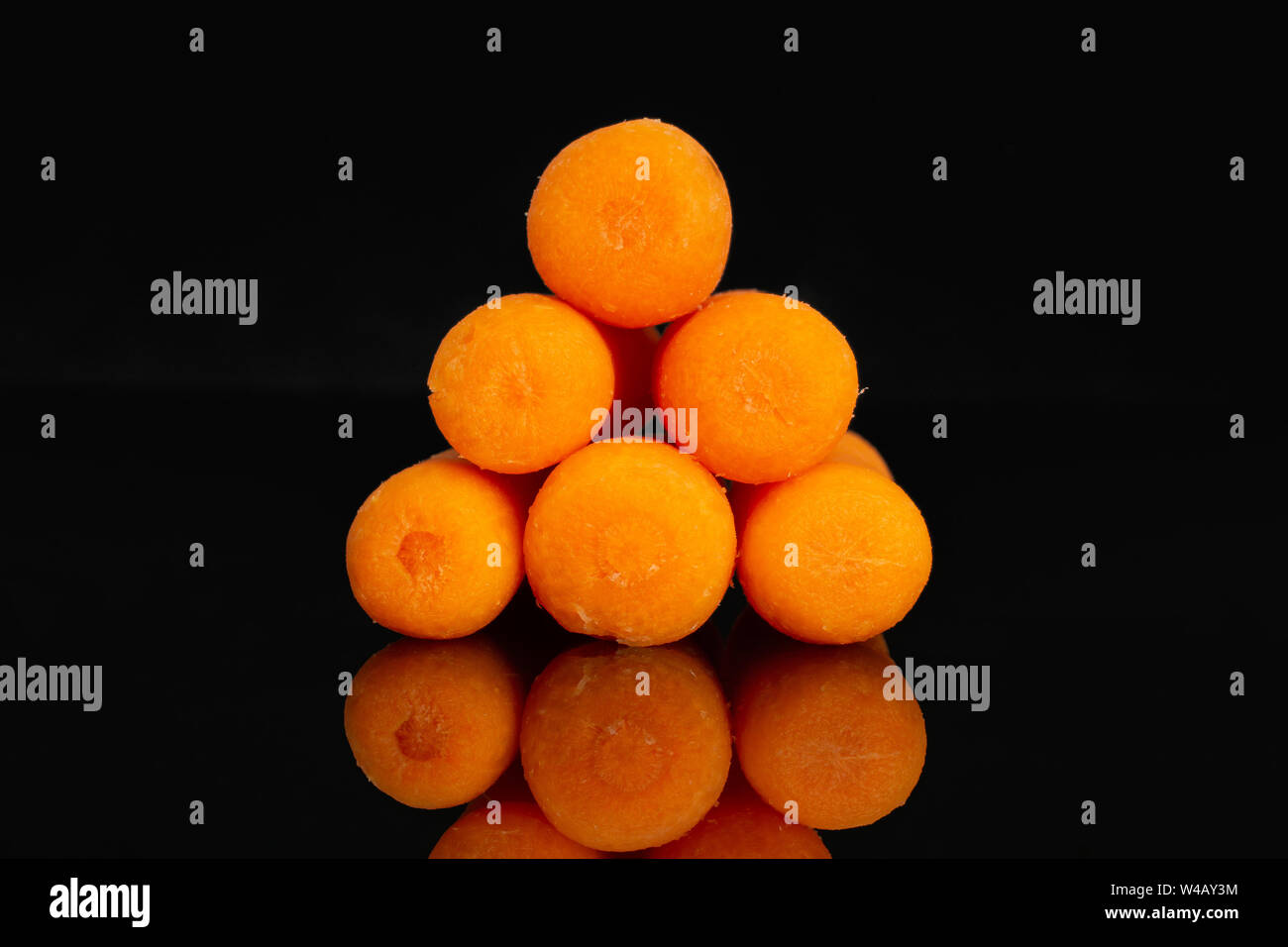 Group of six whole peeled orange baby cut carrot pyramid isolated on ...