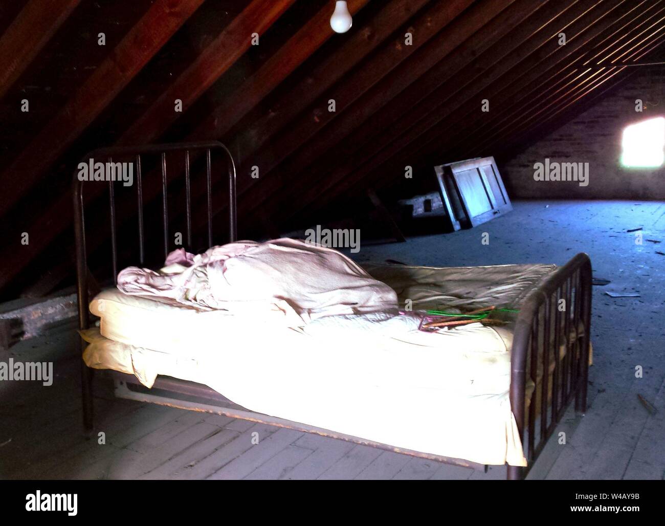 Abandoned bed in attic Stock Photo - Alamy