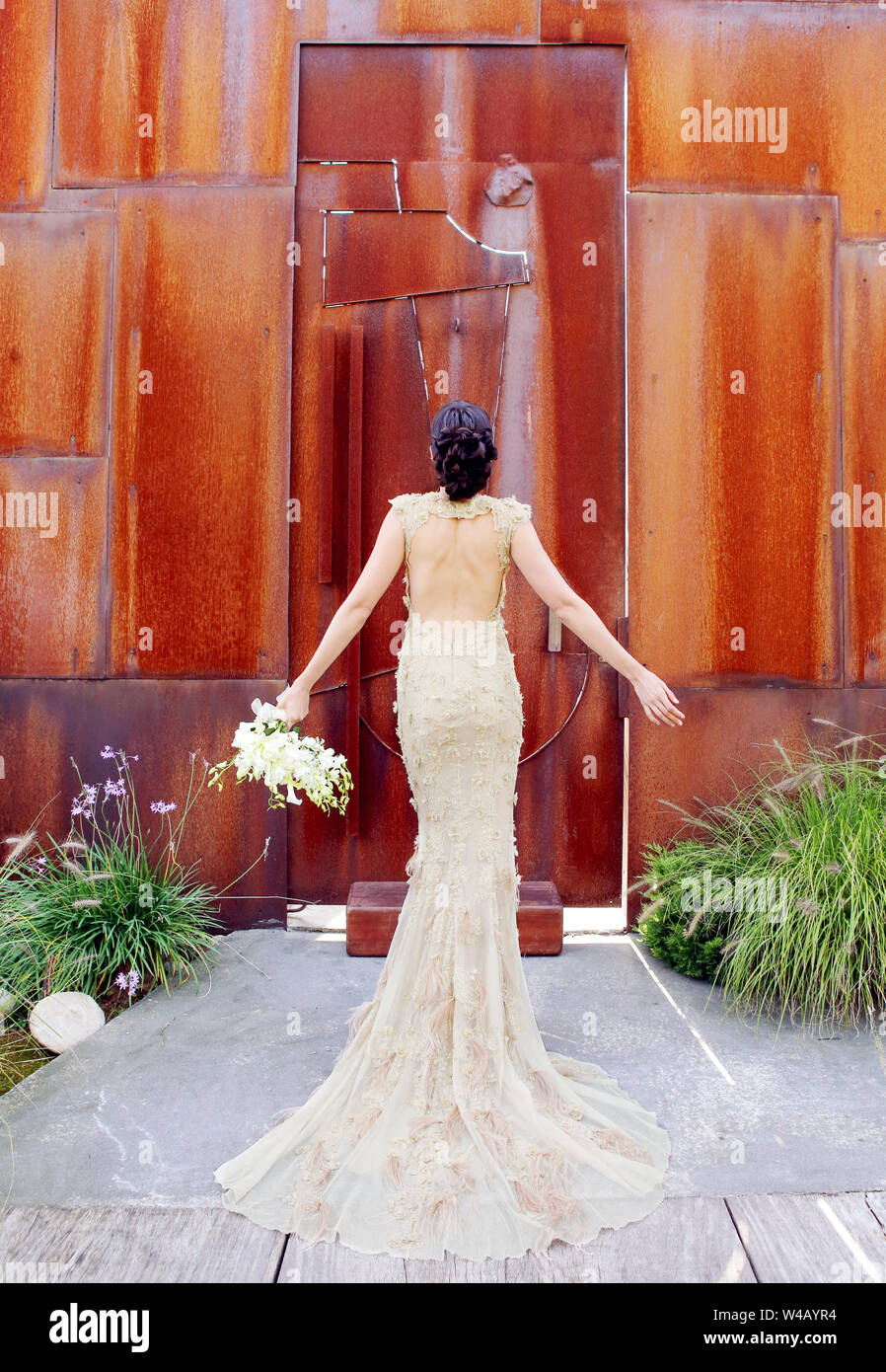 Back view of Bride with Bouquet in custom Lace wedding gown Stock Photo ...
