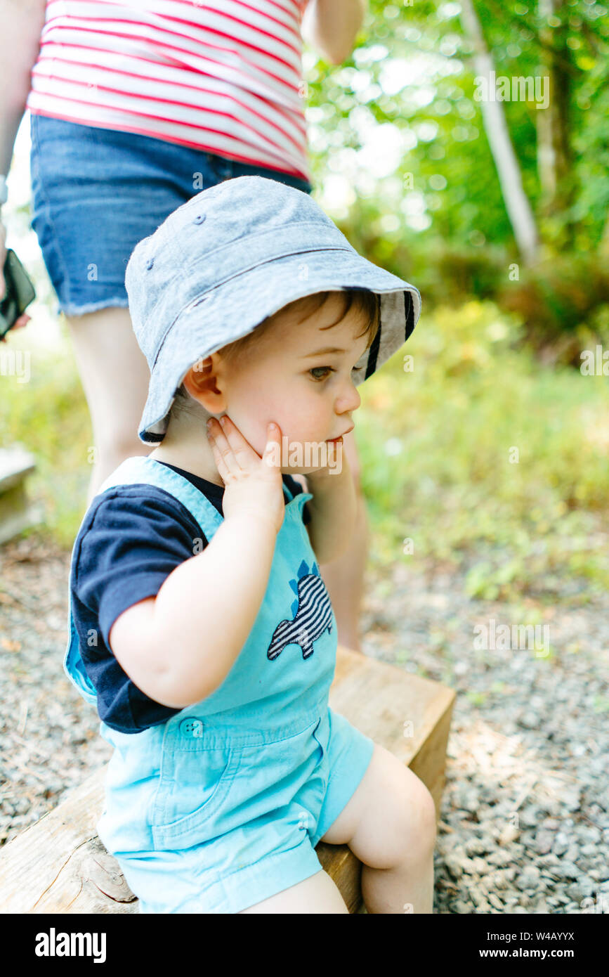 Closeup side view of a young boy wearing a hat in summer Stock Photo ...