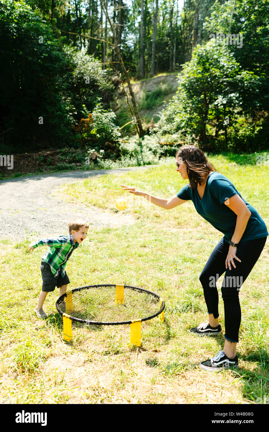 Side view of a woman and a child playing a game while camping Stock ...