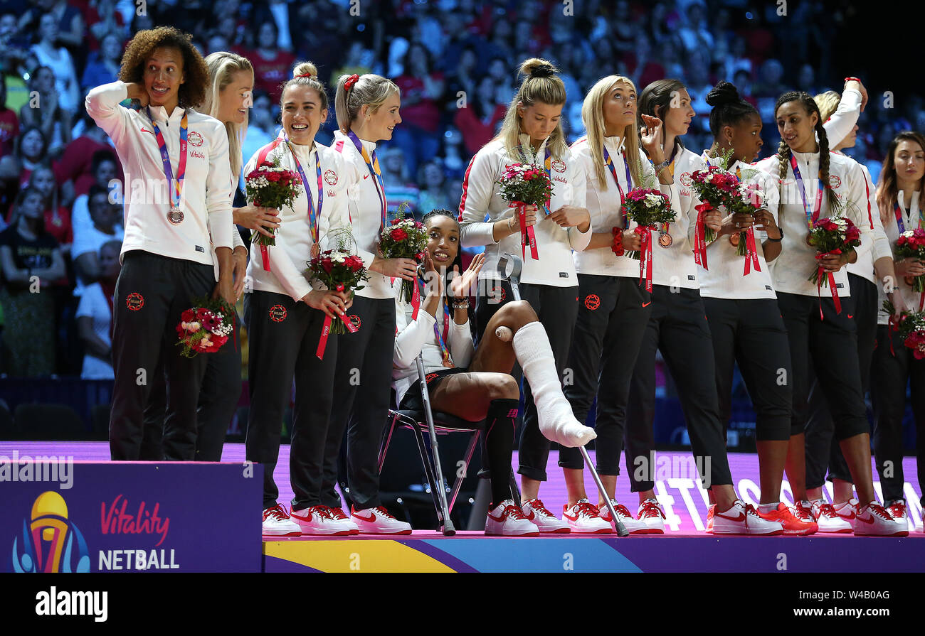 England players celebrate with their bronze medals after finishing ...