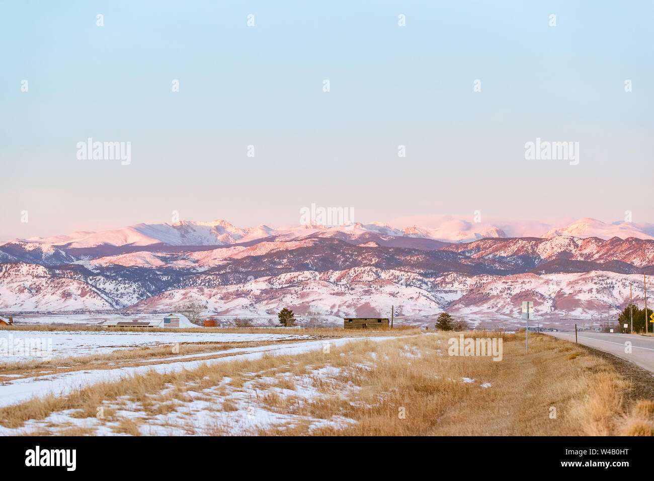 Beautiful Colorado sunrise with snow capped mountains and blue skies ...