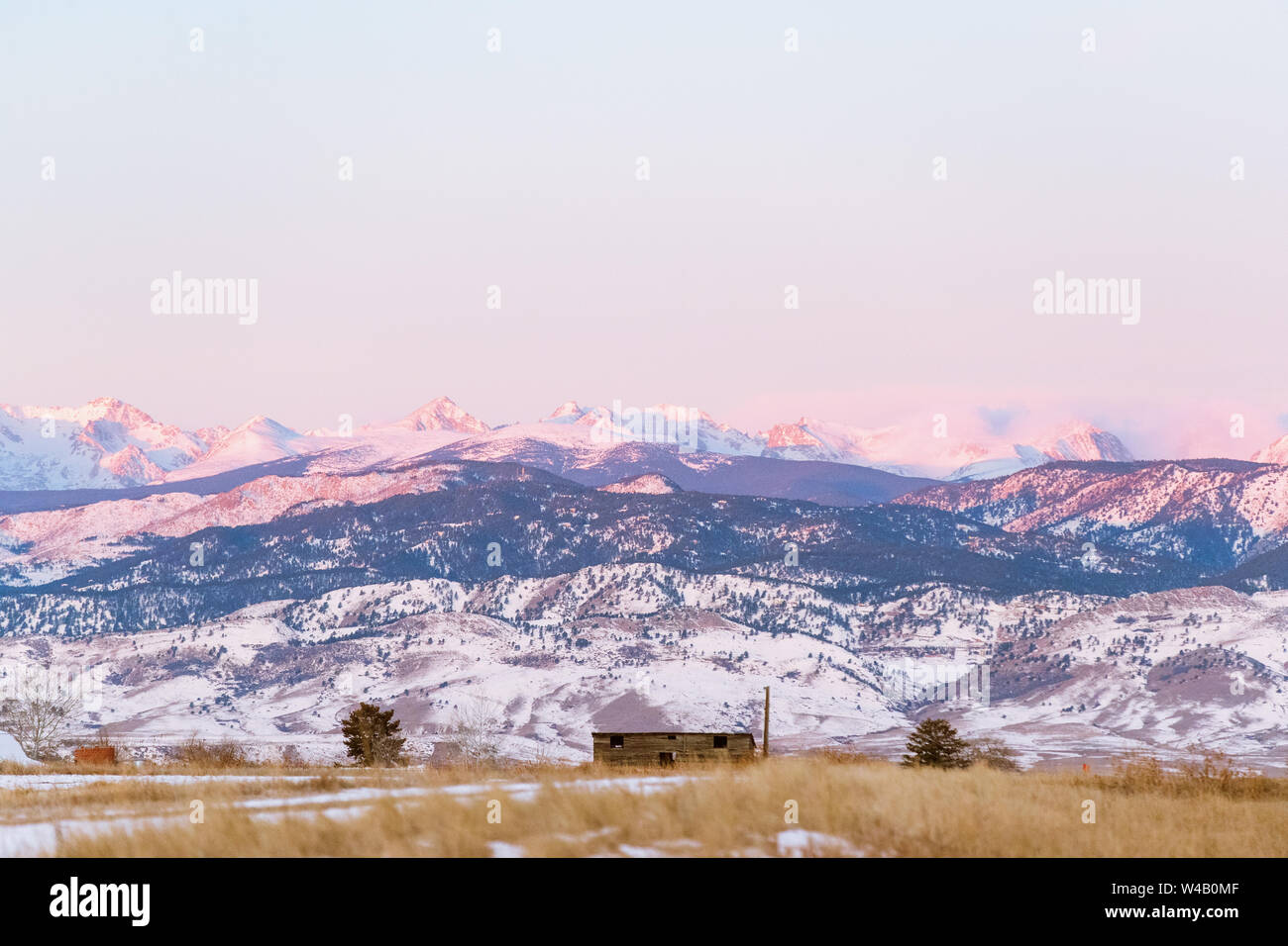 Beautiful Colorado sunrise with snow capped mountains and blue skies ...