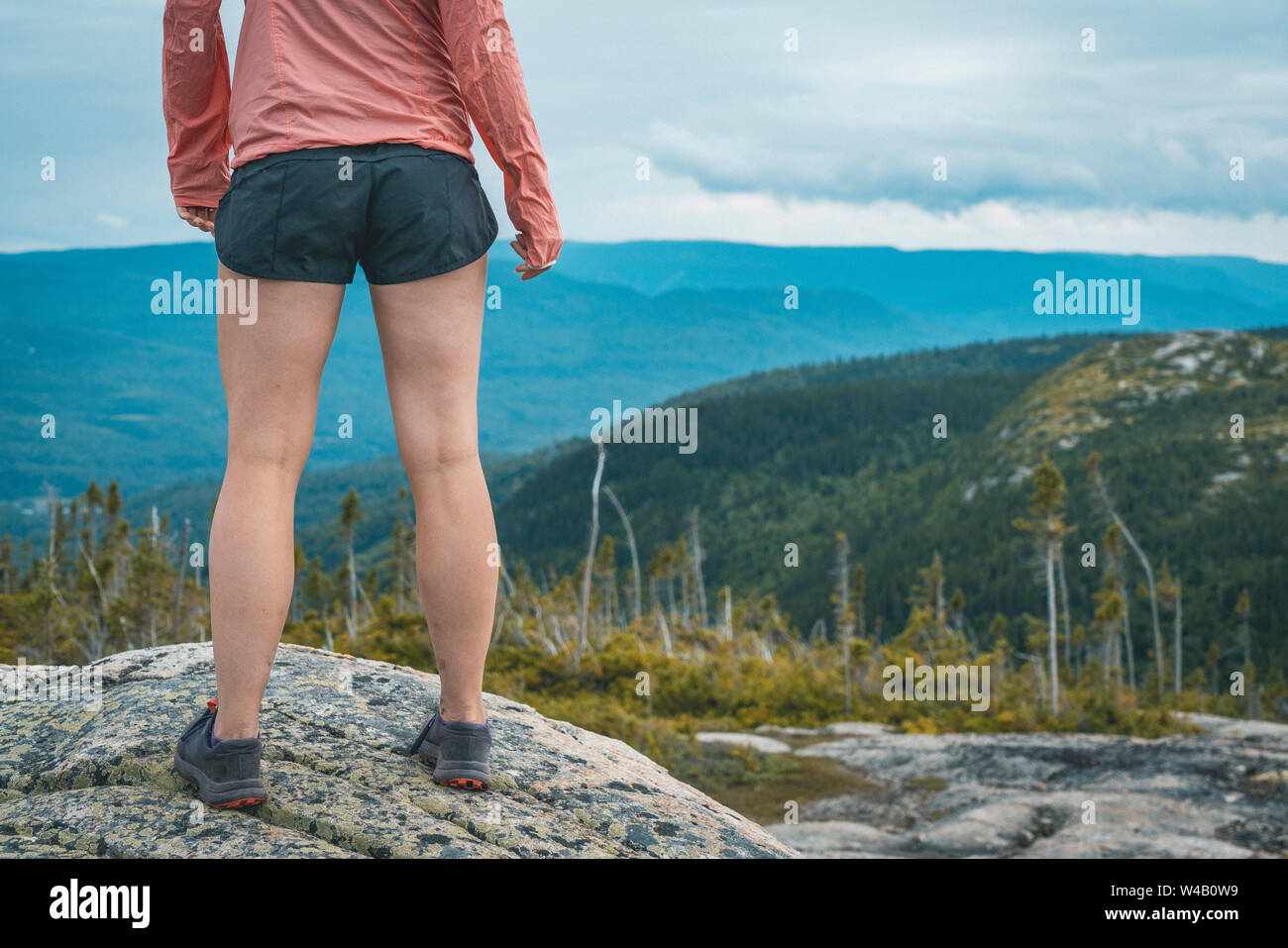 Female Trail Runner Resting on Mountain Ridge Stock Photo - Alamy