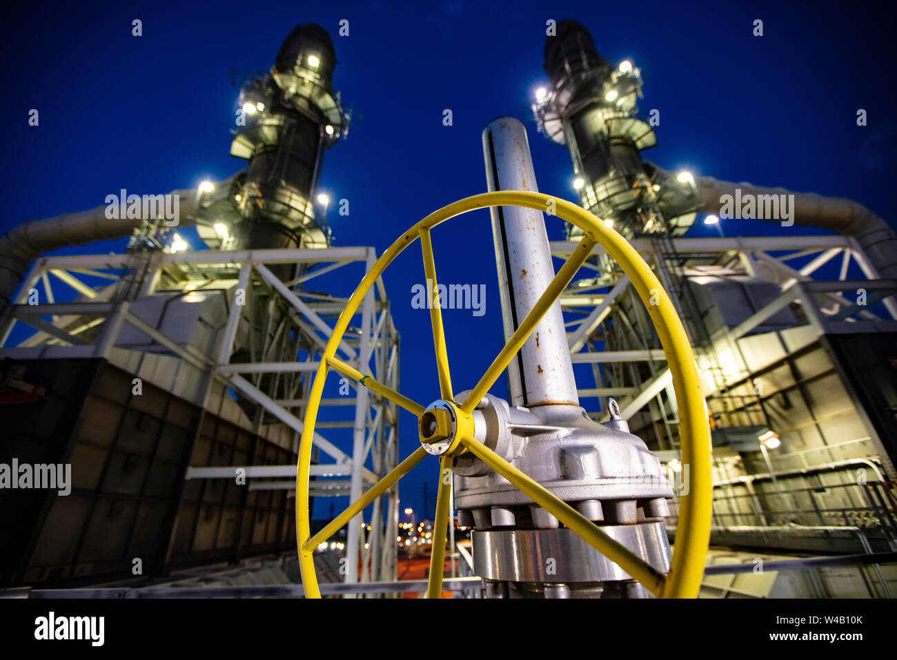 Refinery stacks at dusk Stock Photo - Alamy