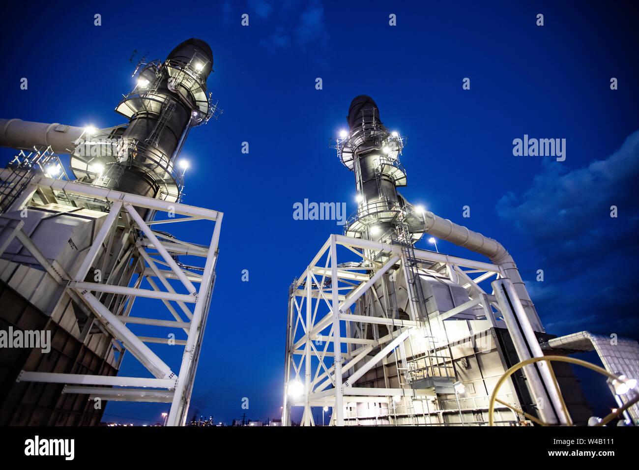 Refinery stacks at dusk in a refinery Stock Photo - Alamy