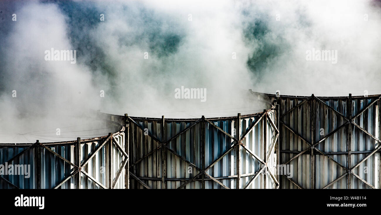 Steam exhaust from cooling towers inside a refinery Stock Photo - Alamy