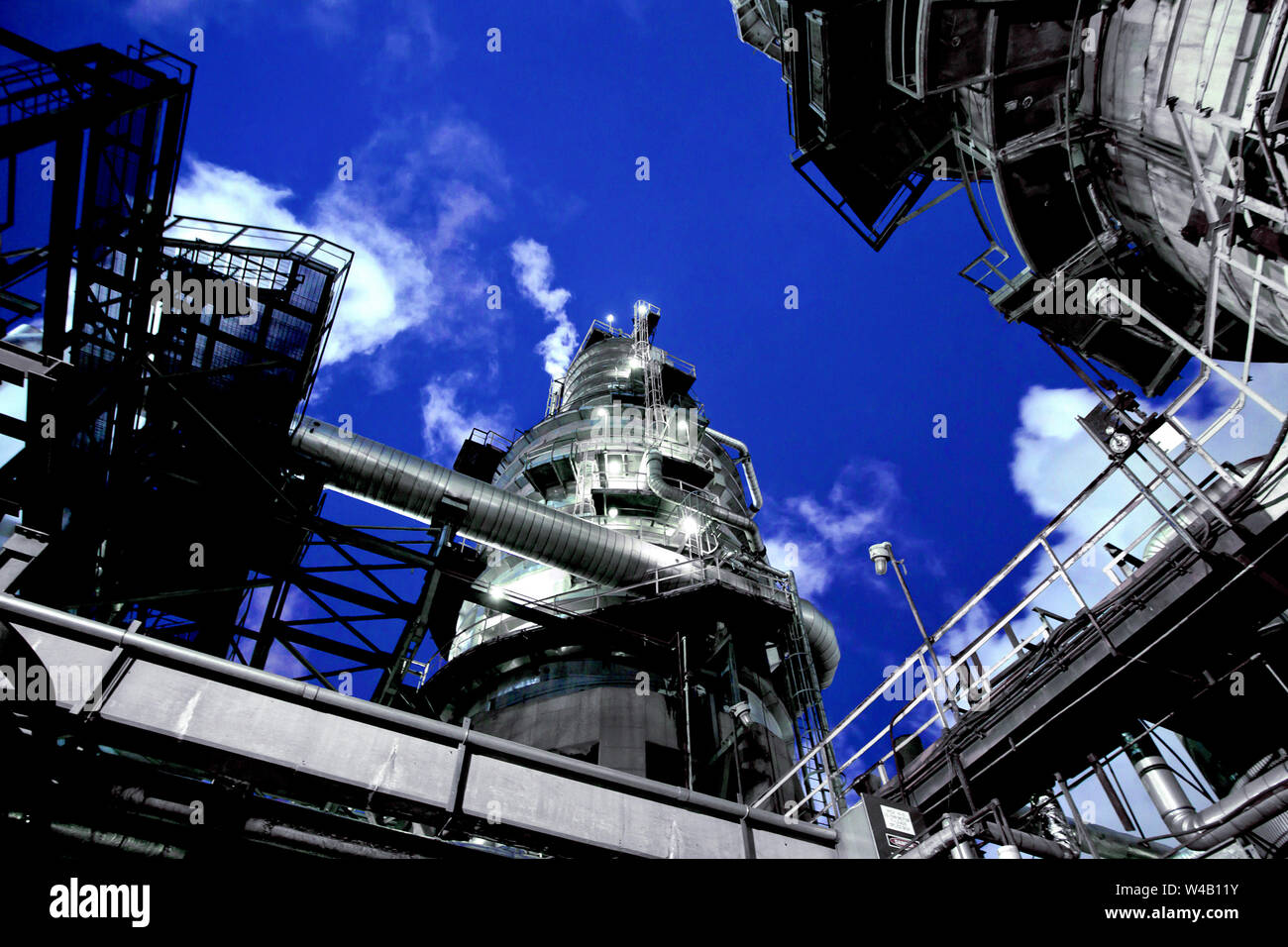 Towers inside a refinery at night time Stock Photo - Alamy