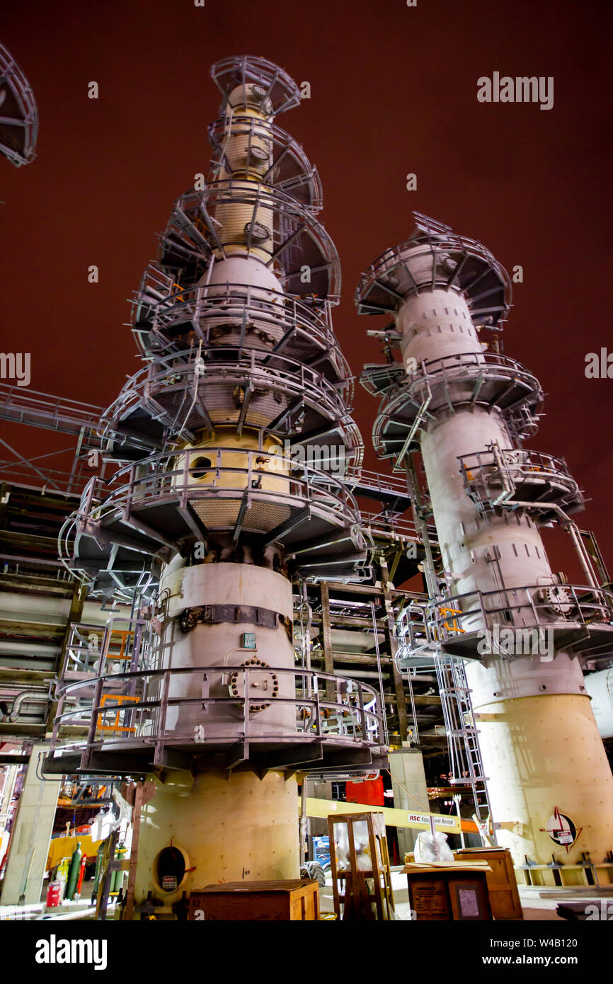 Towers inside a refinery at night time Stock Photo - Alamy
