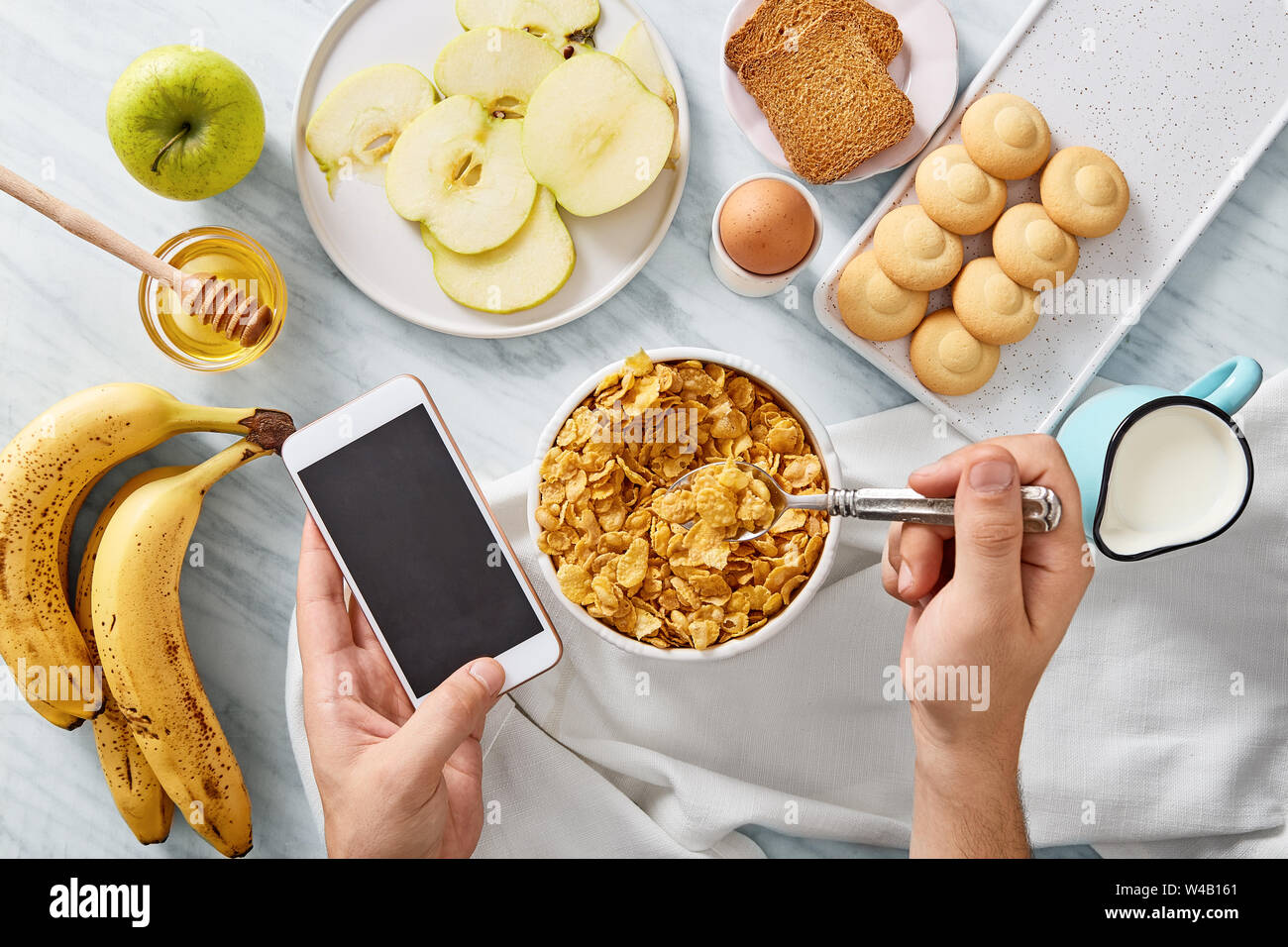 Using phone while eating a breakfast. Healthy breakfast. Top view Stock ...