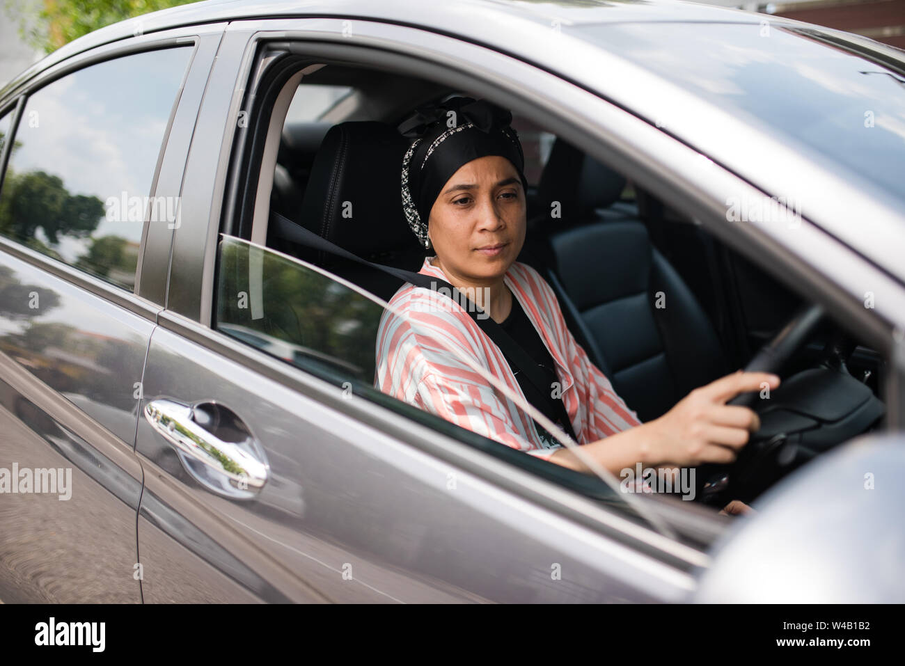 Asian woman driving car Stock Photo - Alamy