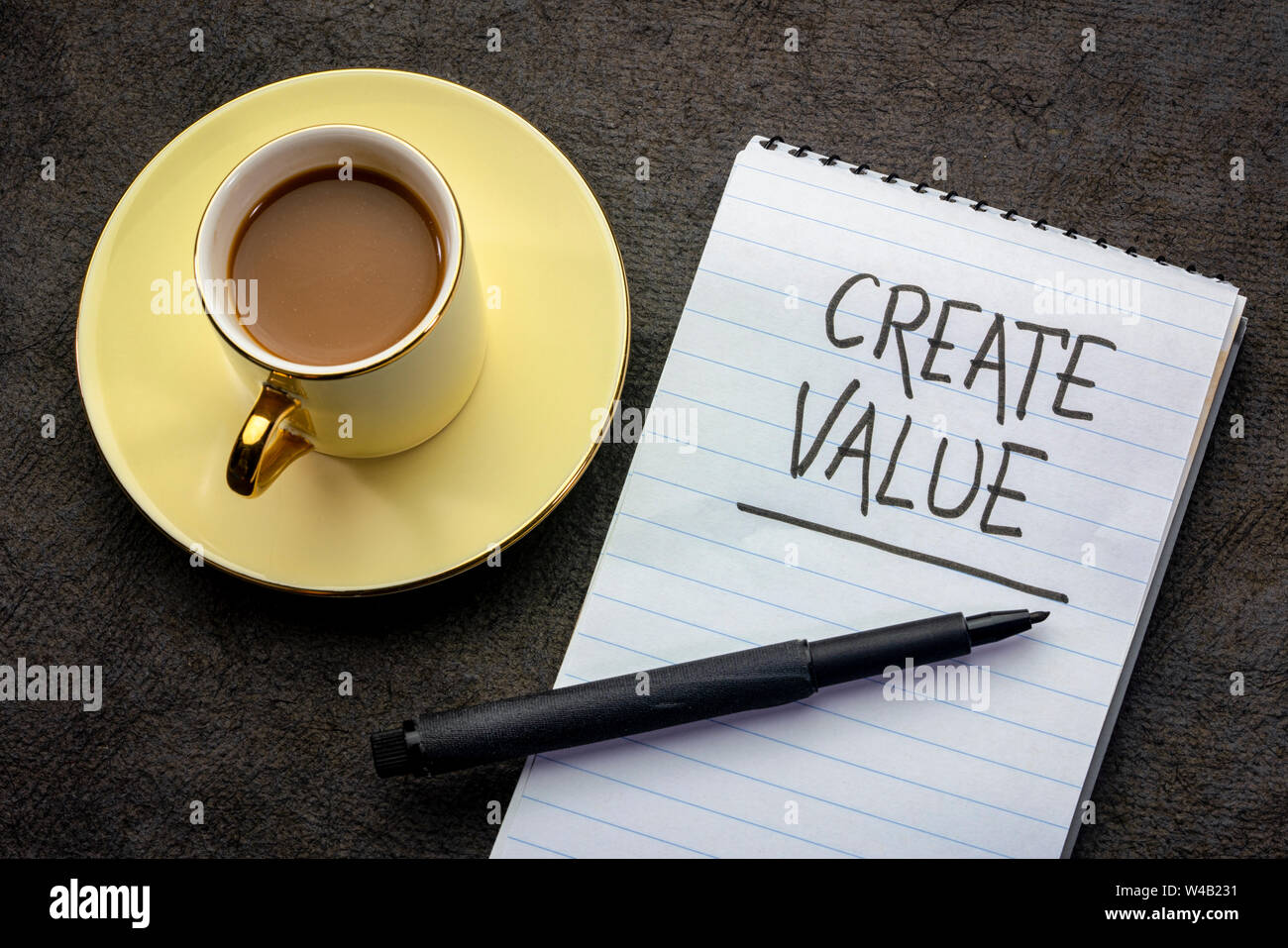 create value - motivational handwriting in a spiral notebook with a cup ...