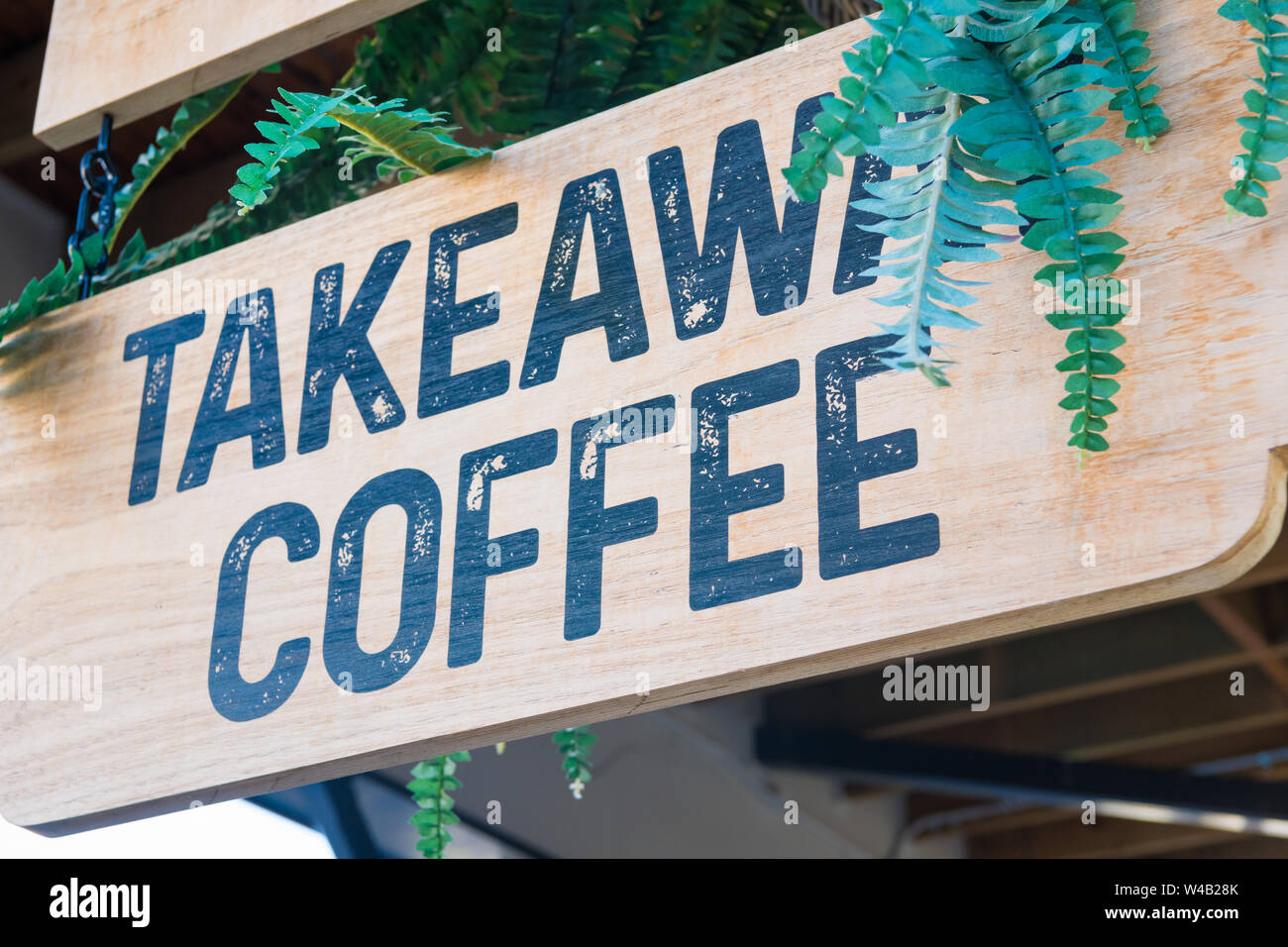 Takeaway coffee sign over wooden board at coffee shop entrance Stock ...