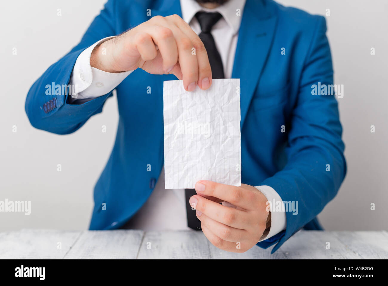 Man holds empty paper with copy space in front of him. White space for ...