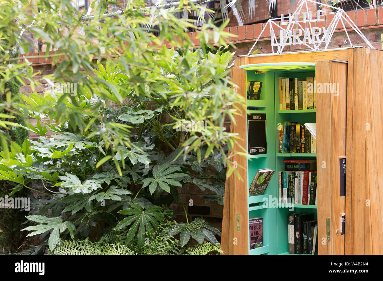 Little library Gibbons Rent secret garden Stock Photo - Alamy