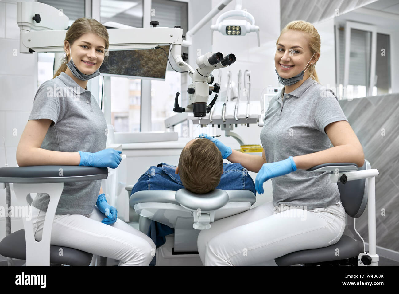 Cheerful dentists posing on camera during their work Stock Photo - Alamy