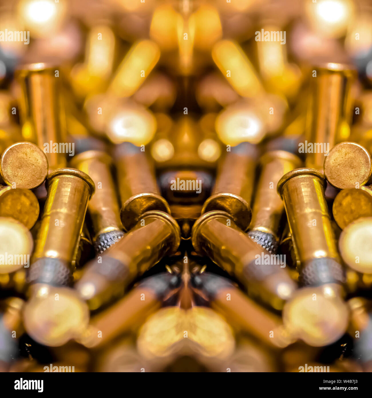 Mirror of two sides of a photo of bullets. Geometric kaleidoscope ...