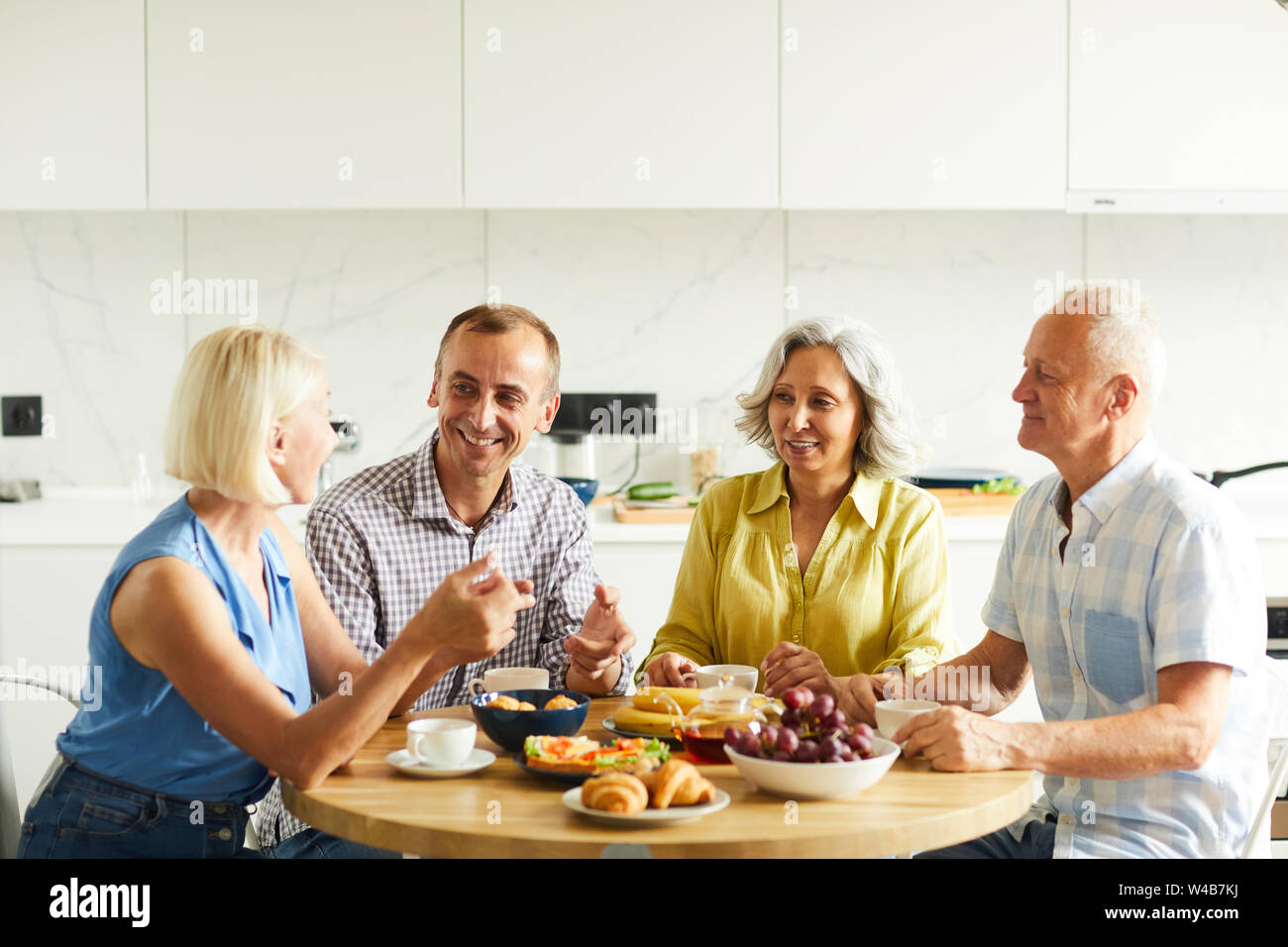 Group people sitting round table hi-res stock photography and images ...