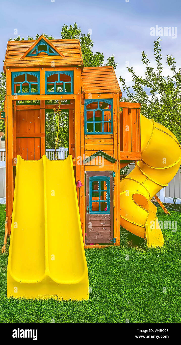 Vertical Playground on a backyard with view of homes and cloudy sky ...