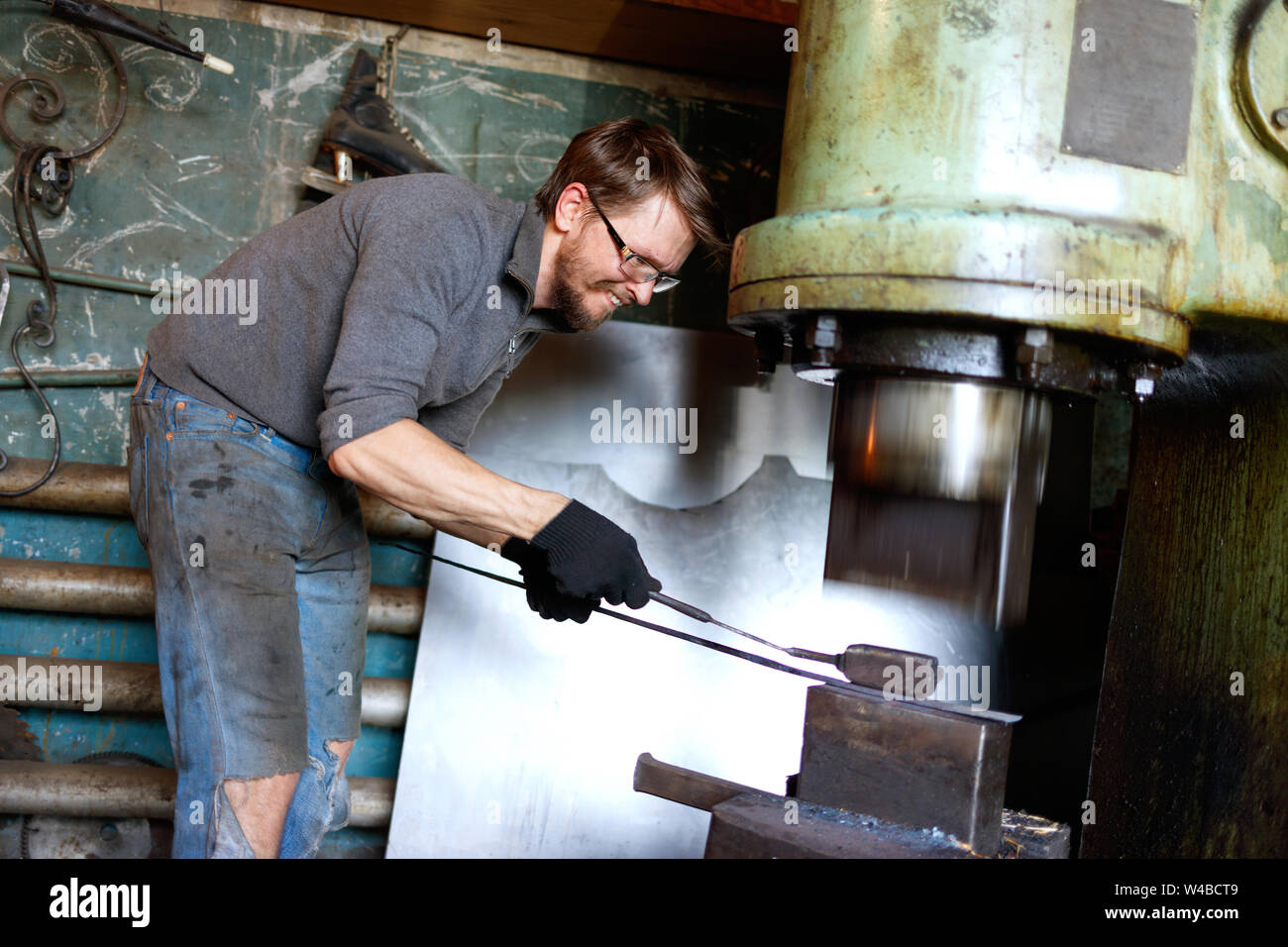 Blacksmith forging by using pneumatic hammer Stock Photo - Alamy