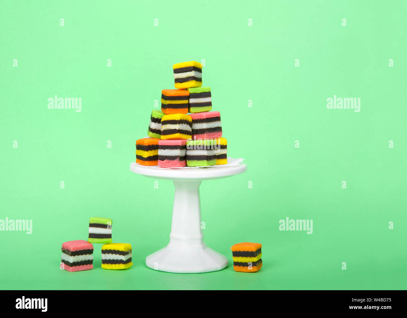 Colorful fancy candy licorice squares piled on a tiny pedestal with ...