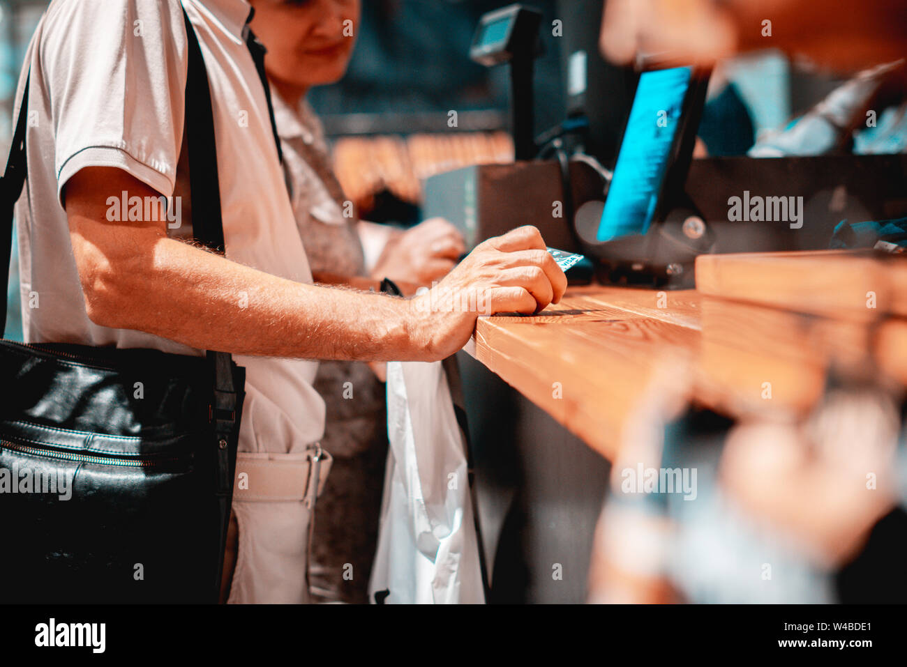 Adult man and woman paying at counter hi-res stock photography and ...