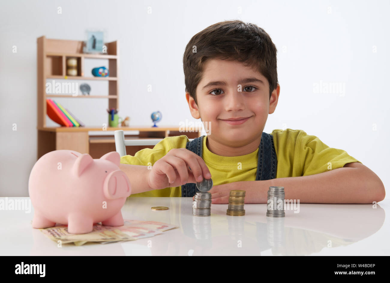 Boy stacking his coins Stock Photo - Alamy